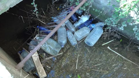 Garbage in a drainage ditch. 4K | Stock Video | Pond5