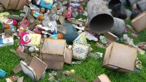 Garbage spilled onto fresh green grass. ... | Stock Video | Pond5