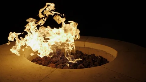 Gas fire pit with lava rocks. Medium ang... | Stock Video | Pond5