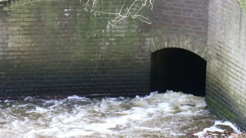 Gate of a dam with water pouring out int... | Stock Video | Pond5