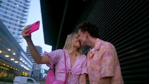 Gen Z couple in pink outfit taking selfi... | Stock Video | Pond5