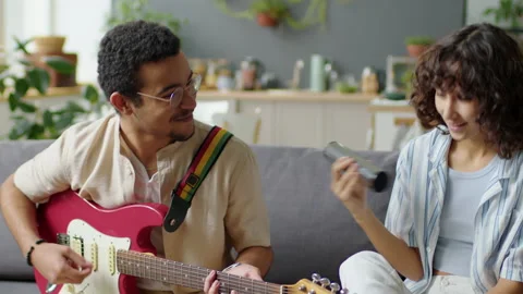 Gen Z Couple Playing Musical Instruments... | Stock Video | Pond5