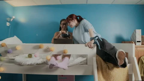 Gen Z Girl Going up Ladder to Top Bunk, ... | Stock Video | Pond5