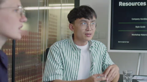 Gen Z Man Talking to Colleagues on Offic... | Stock Video | Pond5