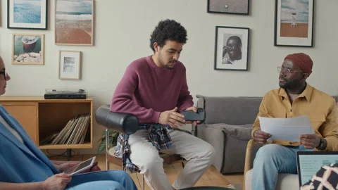 Gen Z Man Talking with Colleagues on Inf... | Stock Video | Pond5