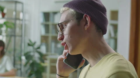 Gen Z Man Talking on Mobile Phone in Off... | Stock Video | Pond5