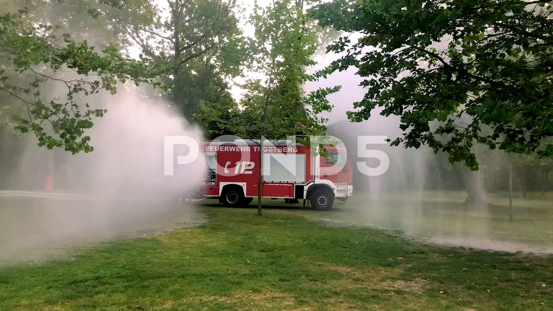 Trucks With Fire Hoses Spraying