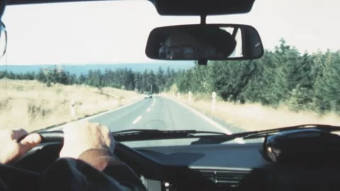 Germany - 1990: A man drives a car on a ... | Stock Video | Pond5