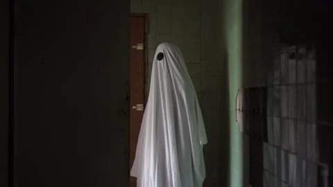 A ghost in a white sheet walks in an old... | Stock Video | Pond5