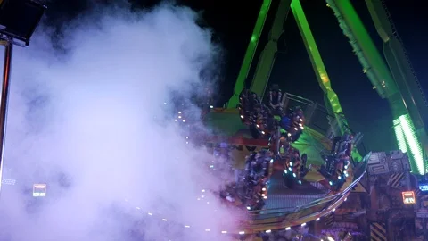 Giant spinning carousel with smoke,peopl... | Stock Video | Pond5