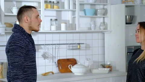 girl and boy hug in the kitchen | Stock Video | Pond5