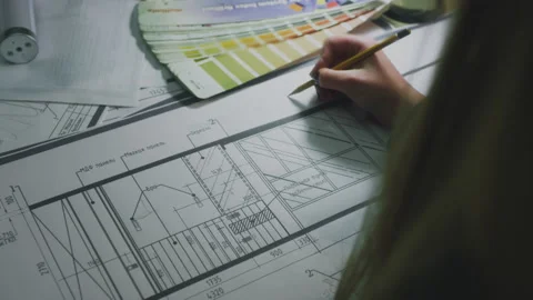 A girl architect creates a drawing of a ... | Stock Video | Pond5