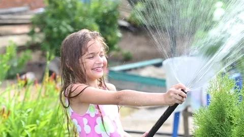 A girl in a bathing suit splashes water ... | Stock Video | Pond5