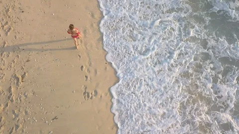 Girl in bikini walk on the sand beach wi... | Stock Video | Pond5