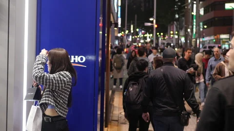 Girl checking her appearance in store wi... | Stock Video | Pond5