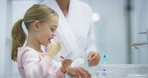 Girl, child and mother toothbrush in bat... | Stock Video | Pond5