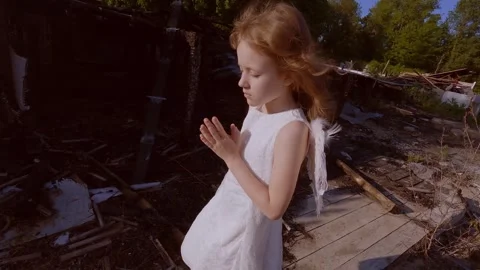 Girl child on the background of a burned... | Stock Video | Pond5