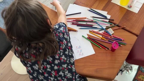 girl child drawing picture top view | Stock Video | Pond5