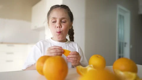 girl child eating oranges. happy family ... | Stock Video | Pond5
