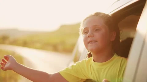 girl child travel in car. happy kid wavi... | Stock Video | Pond5
