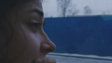 Girl is crying at the window | Stock Video | Pond5