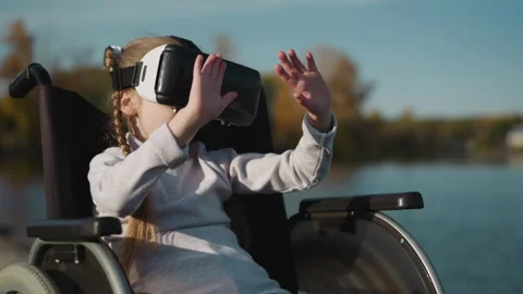 Girl with disability looks at hands thro... | Stock Video | Pond5