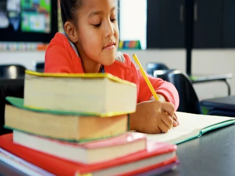 Girl doing homework in classroom 4k | Stock Video | Pond5