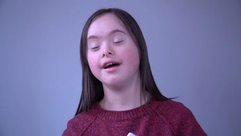 Girl with Down Syndrome have fun with di... | Stock Video | Pond5