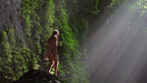 Girl in dress walks into sun rays at Tuk... | Stock Video | Pond5