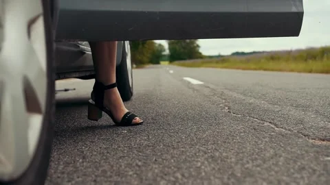The girl driver gets out of the car. Her... | Stock Video | Pond5