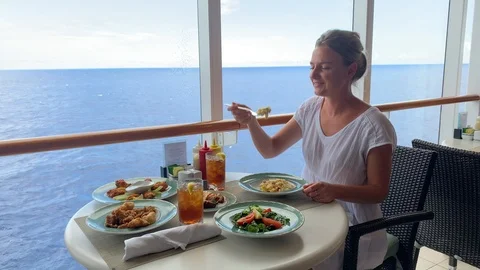 Girl eating macaroni cheese of ocean vie... | Stock Video | Pond5