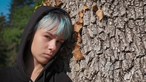 Girl feeling guilty by tree. | Stock Video | Pond5