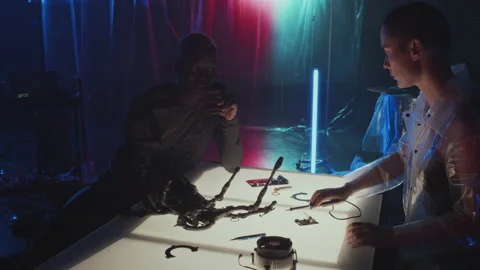 Girl Fixing Robotic Arm of Guy | Stock Video | Pond5