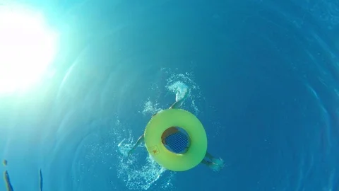 Girl floating on inflatable ring in swim... | Stock Video | Pond5