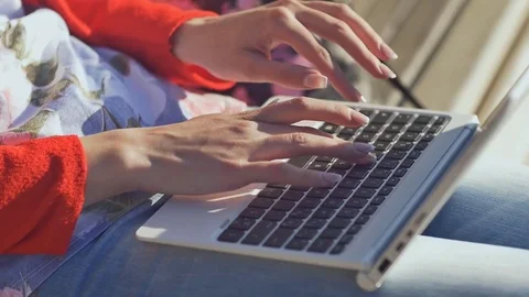 Girl in the fresh air typing on the keyb... | Stock Video | Pond5