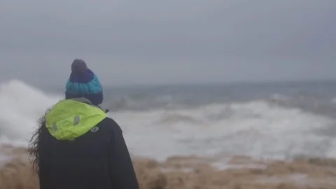 a girl in front of a storm big waves exp... | Stock Video | Pond5