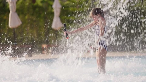 Girl Gets Splashed By Water In A Waterpa... | Stock Video | Pond5