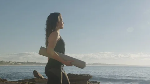 Girl going to exercise by the ocean. Wal... | Stock Video | Pond5