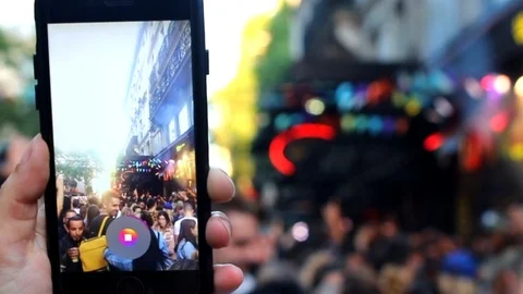 Girl hand filming a street concert with ... | Stock Video | Pond5