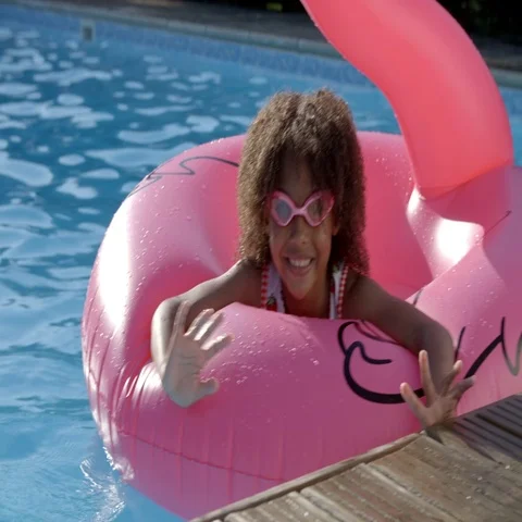 Girl Having Fun With Inflatable In Outdo... | Stock Video | Pond5
