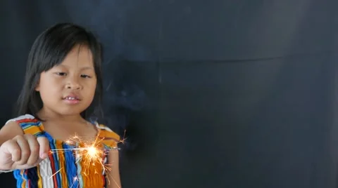 girl having fun with sparkles on black b... | Stock Video | Pond5