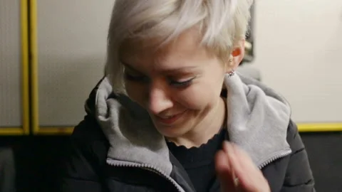 The girl hesitates, smiles, covers his f... | Stock Video | Pond5