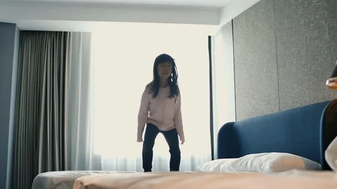 Girl Jump Up Bed Stock Video Footage | Royalty Free Girl Jump Up Bed Videos | Pond5