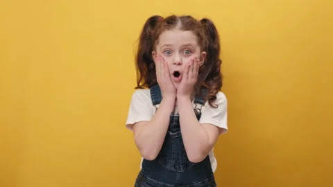 Girl kid looking surprised at camera wit... | Stock Video | Pond5
