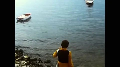 girl by the lake in the 70s | Stock Video | Pond5