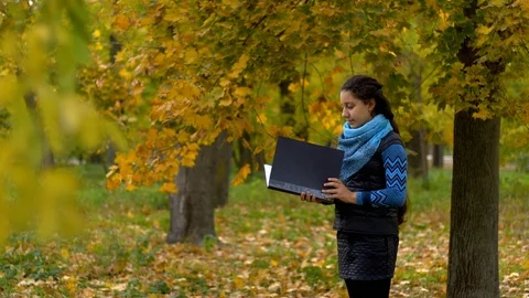 girl leafing through an album under an a... | Stock Video | Pond5