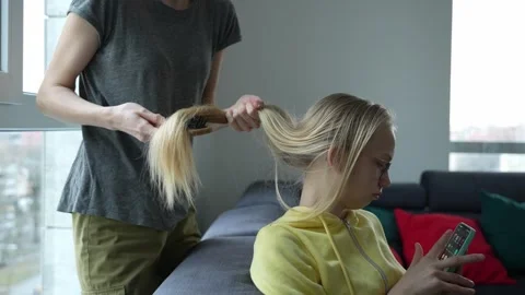 Girl with long blond hair scrolls the ph... | Stock Video | Pond5
