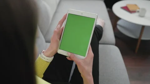 Girl Looking at Tablet with Green Screen... | Stock Video | Pond5