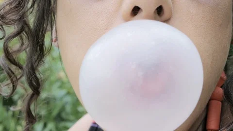 girl making a bubble from chewing gum, c... | Stock Video | Pond5