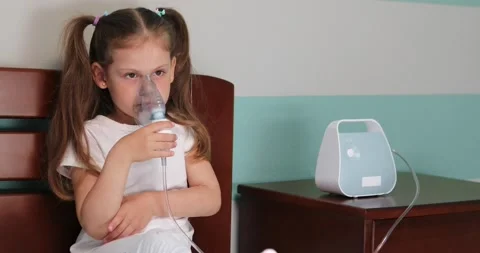 Girl making inhalation with nebulizer at... | Stock Video | Pond5